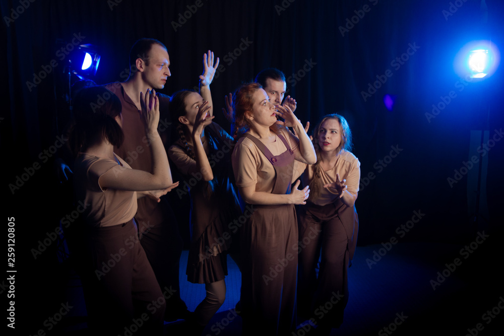 The actors on the stage play an emotion performance on a black ...