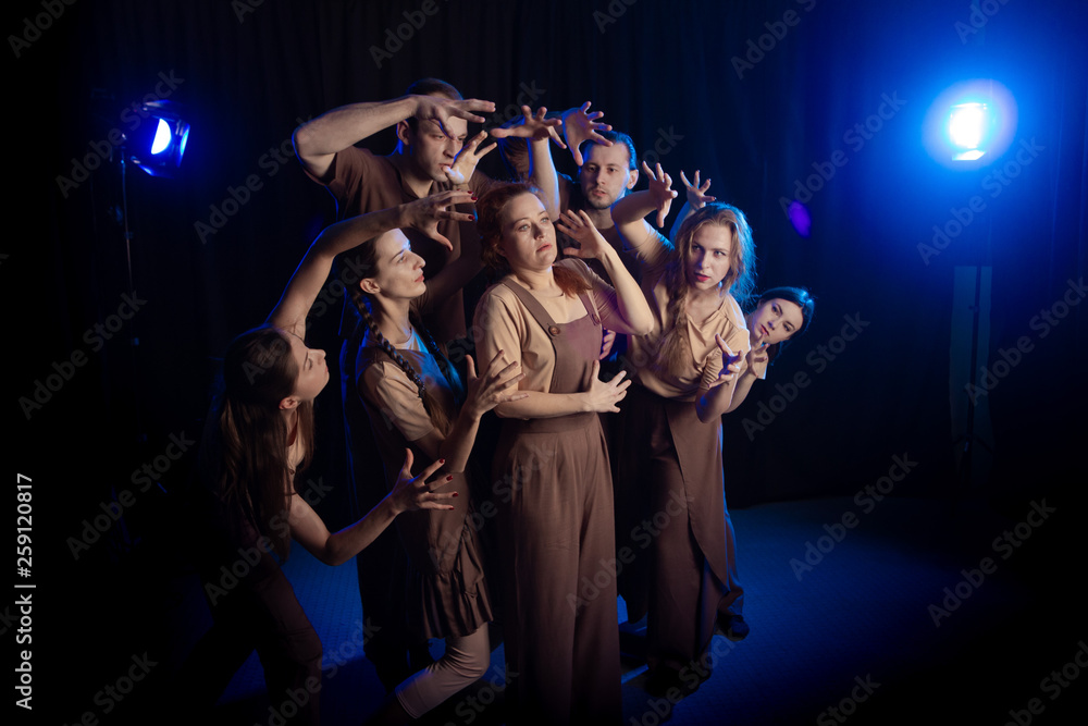 The actors on the stage play an emotion performance on a black ...