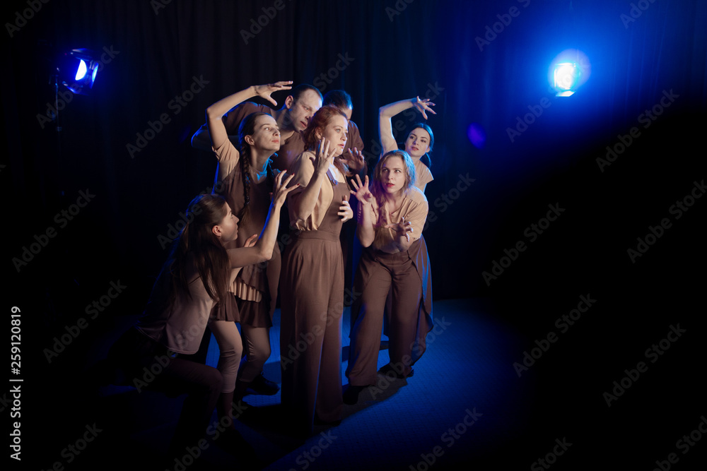 The actors on the stage play an emotion performance on a black ...