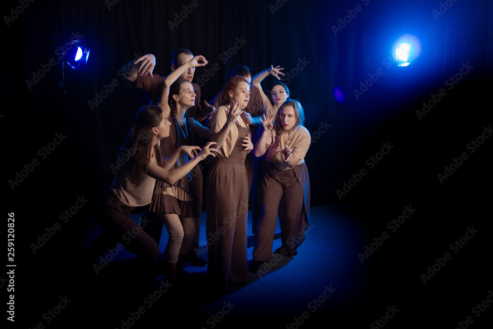 The actors on the stage play an emotion performance on a black ...