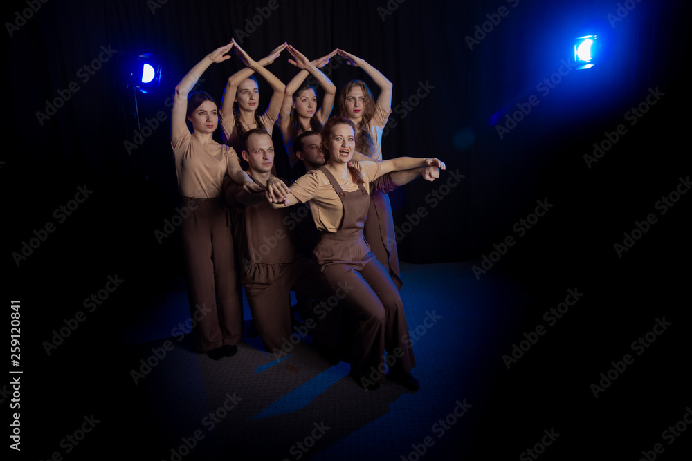 The actors on the stage play an emotion performance on a black ...