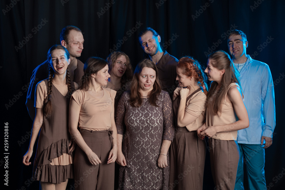 The actors on the stage play an emotion performance on a black ...