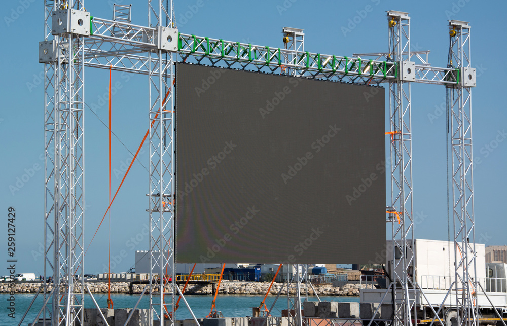 Big open-air black outdoor LED screen for public music event at sea ...