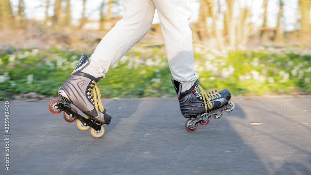Legs on inline skates. Man roller skater in speed hard shell skates ...