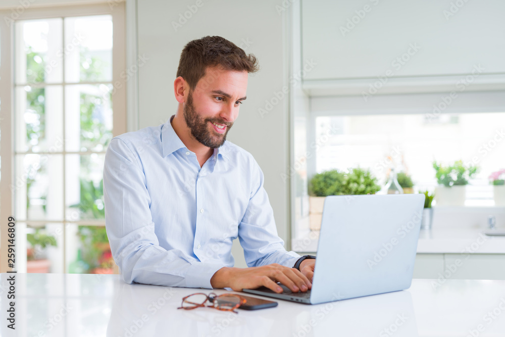 Handsome business man working using computer laptop with a happy face ...