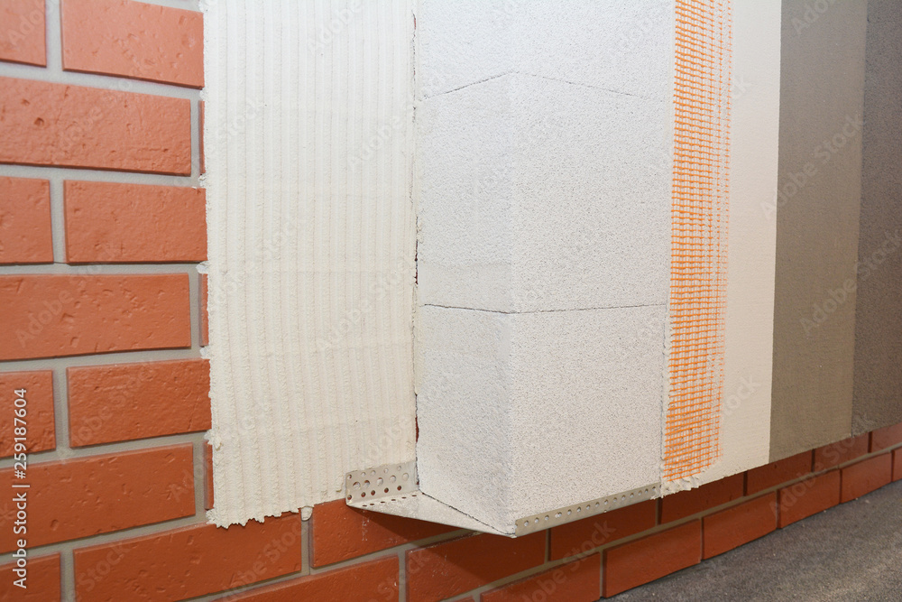 House brick wall renovation, insualtion with glue plastering layers ...