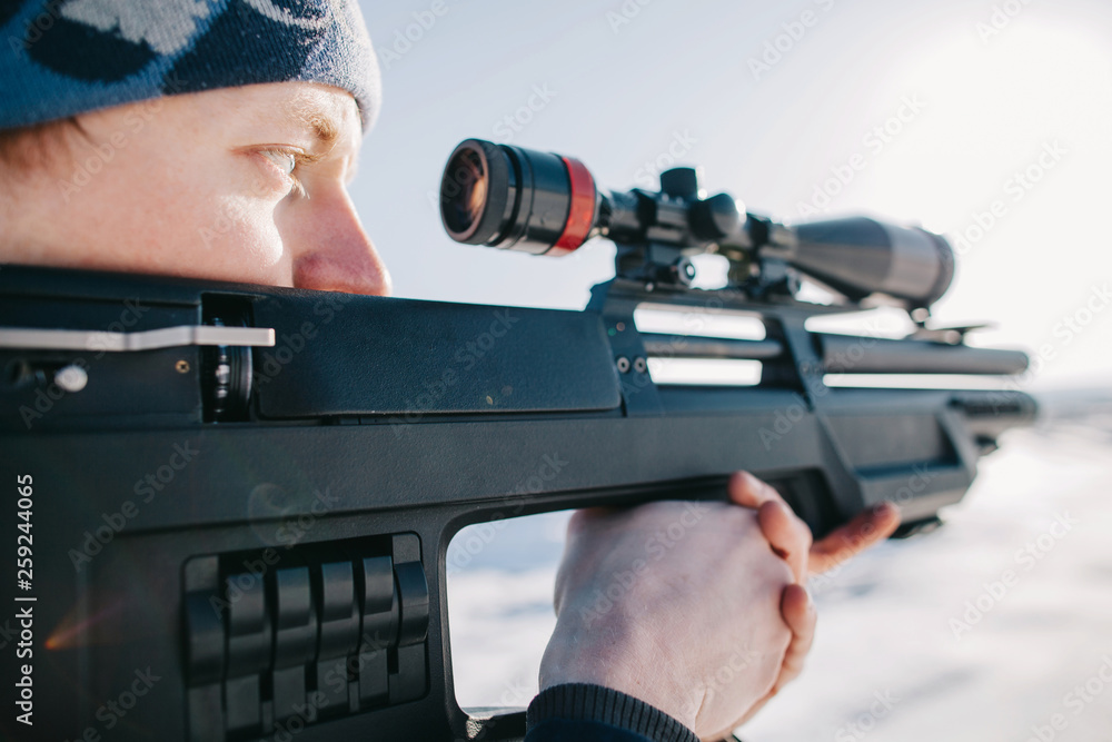 Side view closeup portrait of man aiming with rifle Stock Photo | Adobe ...