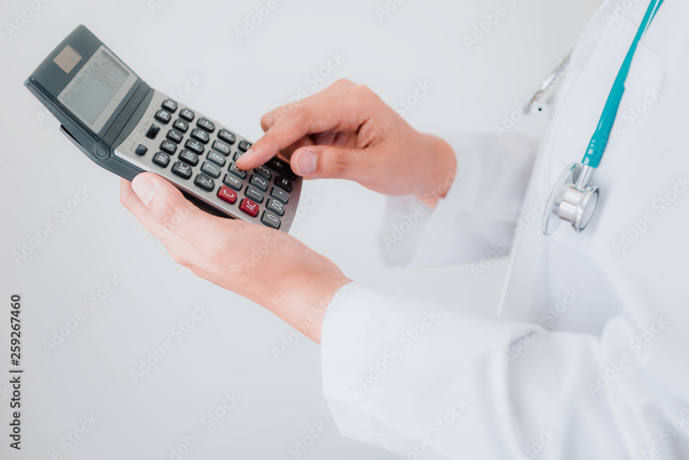 Close-Up of Female Physician Doctor Using Calculator for Calculate ...