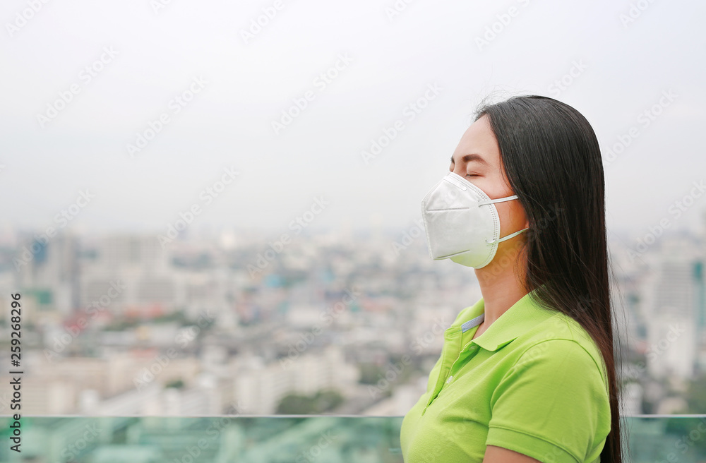 Young Asian woman wearing a protection mask against PM 2.5 air ...