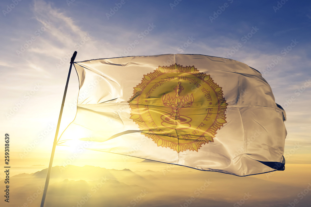 Maharashtra state of India flag waving on the top sunrise mist fog ...