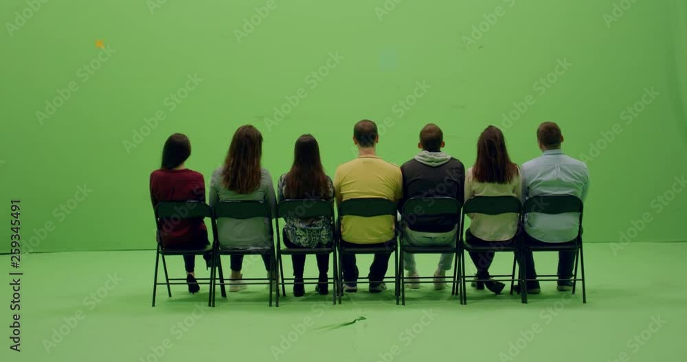 GREEN SCREEN CHROMA KEY Back view group of young people sitting on ...