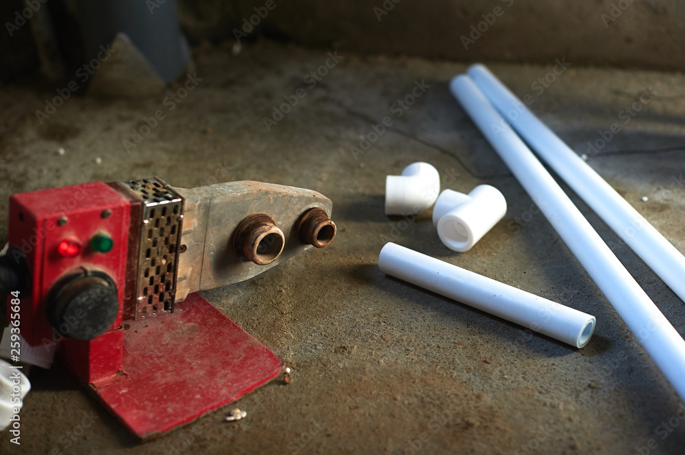 Plumber welded plastic pipes. Installation of PVC pipes for heating ...