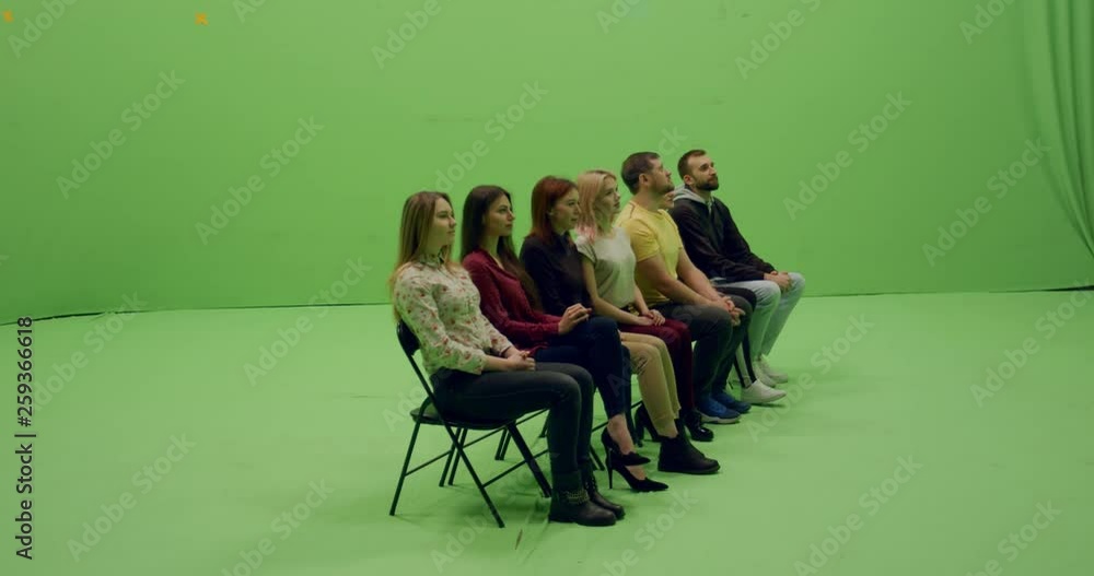GREEN SCREEN CHROMA KEY Front view group of young people sitting and ...