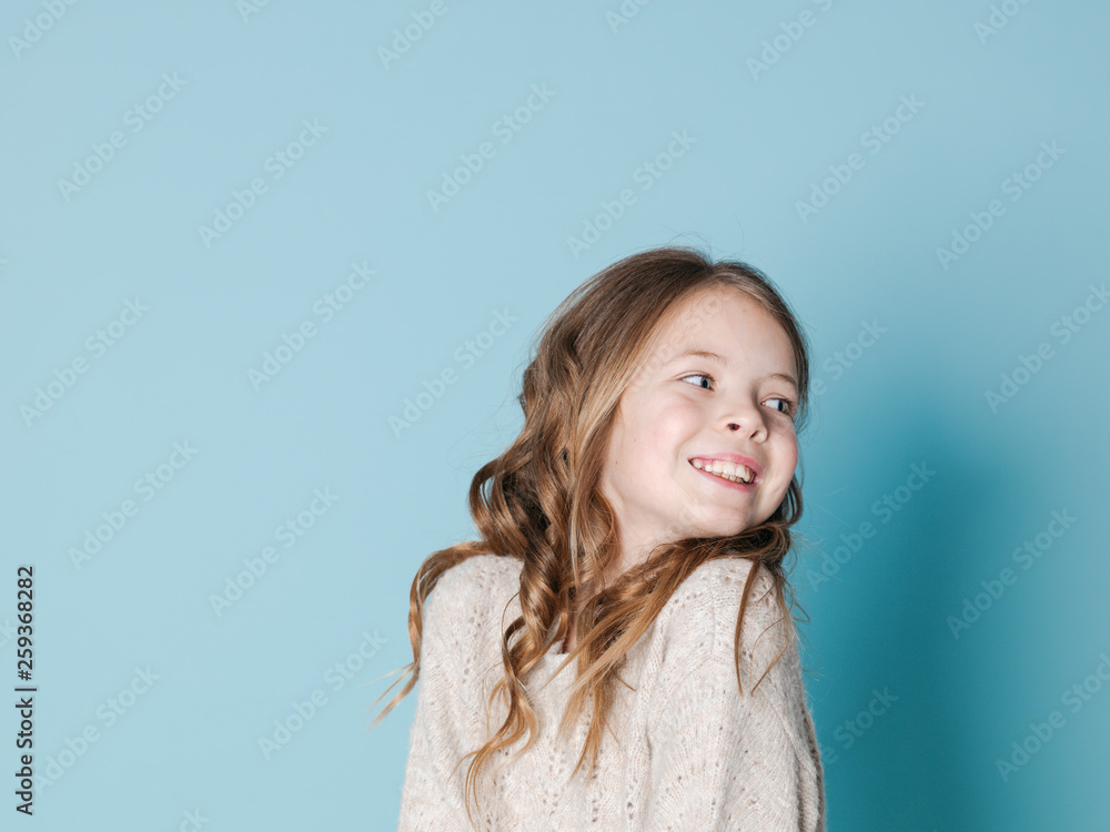 pretty and cool 9 year old girl with brown wool sweater posing in front ...