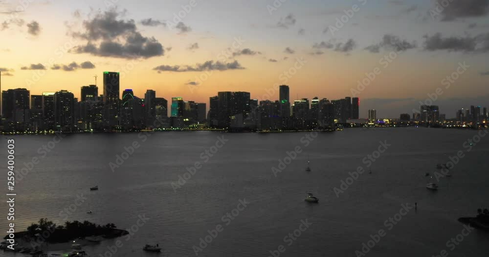 Slow, pull out aerial shot of the Brickell skyline during a colorful ...