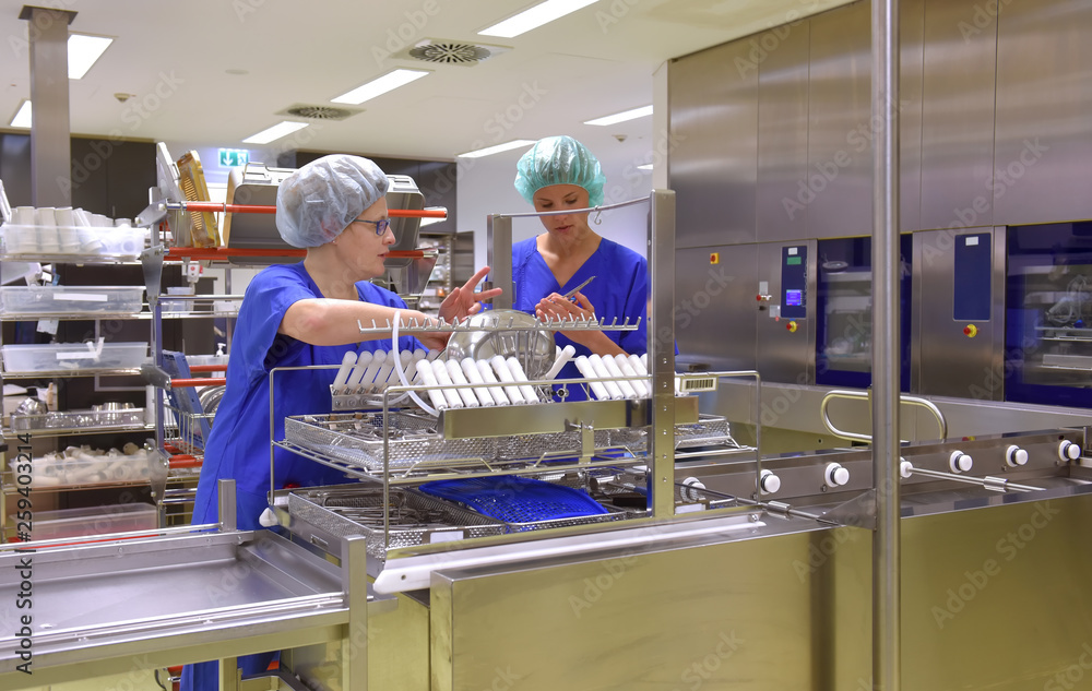 Two women work in a hospital as medical hygiene technicians. They are ...