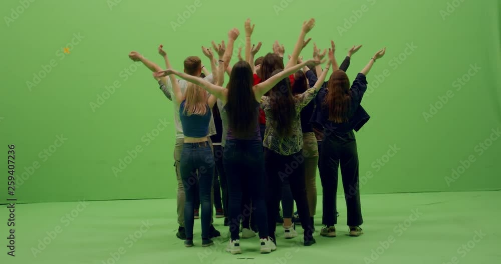 GREEN SCREEN CHROMA KEY Back view group of young people standing and ...