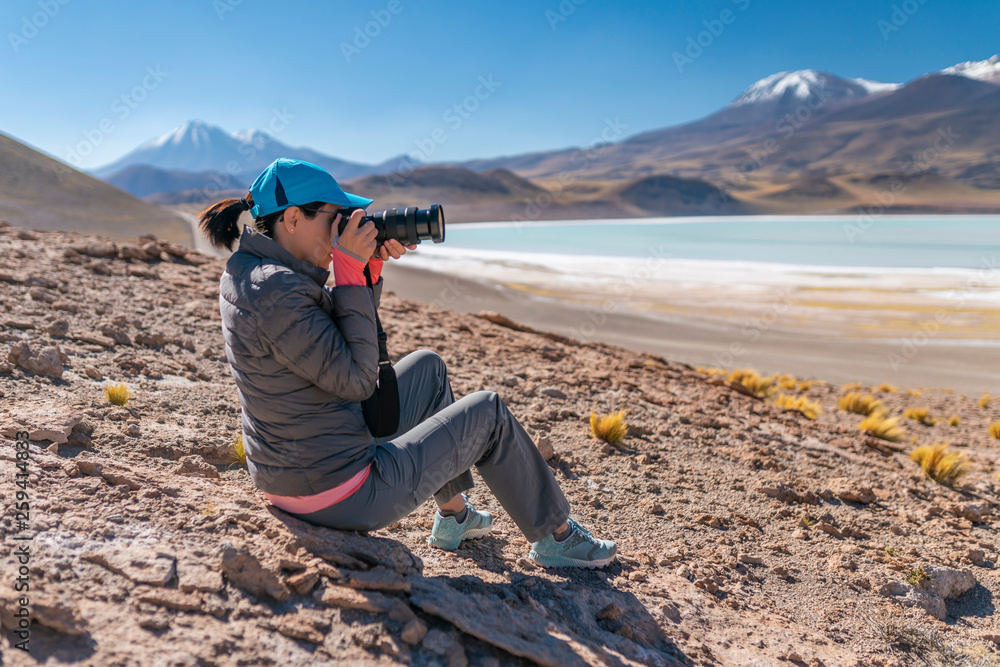 Landscape woman photographer taking photos in an amazing wilderness ...