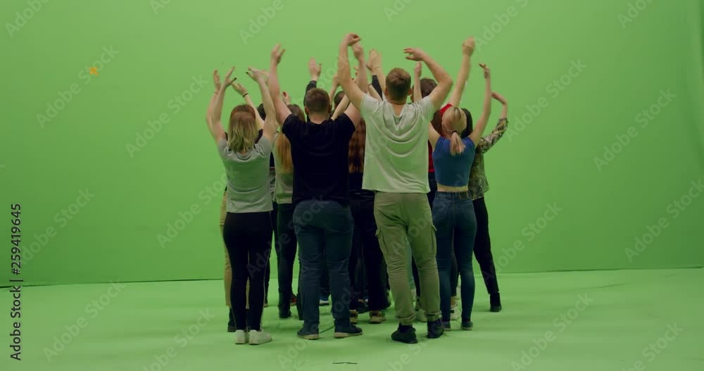GREEN SCREEN CHROMA KEY Back view group of young people standing and ...