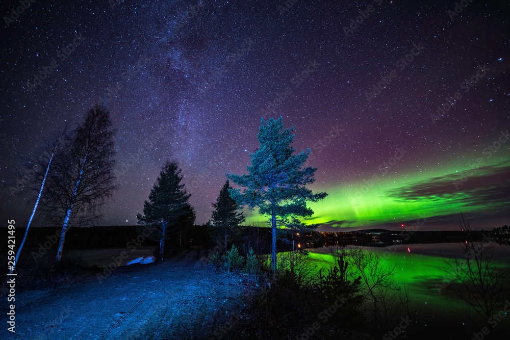 Aurora at clear skies and like reflecting green northern lights like ...