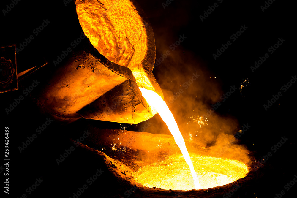 metal casting process with red high temperature fire in metal part ...