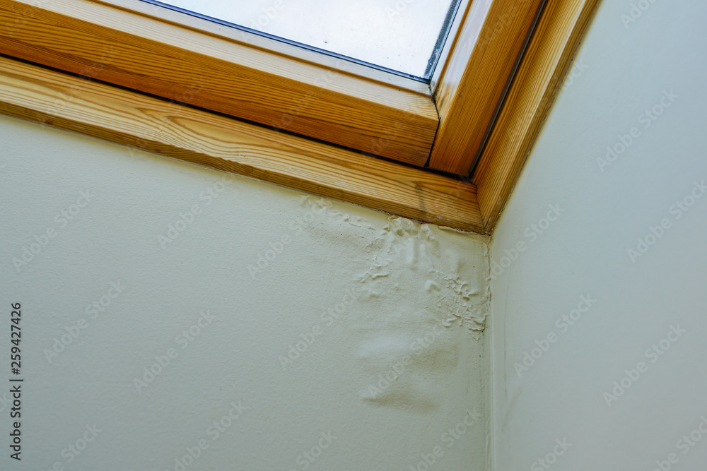 water and moisture damaged ceiling next to roof window Stock Photo ...