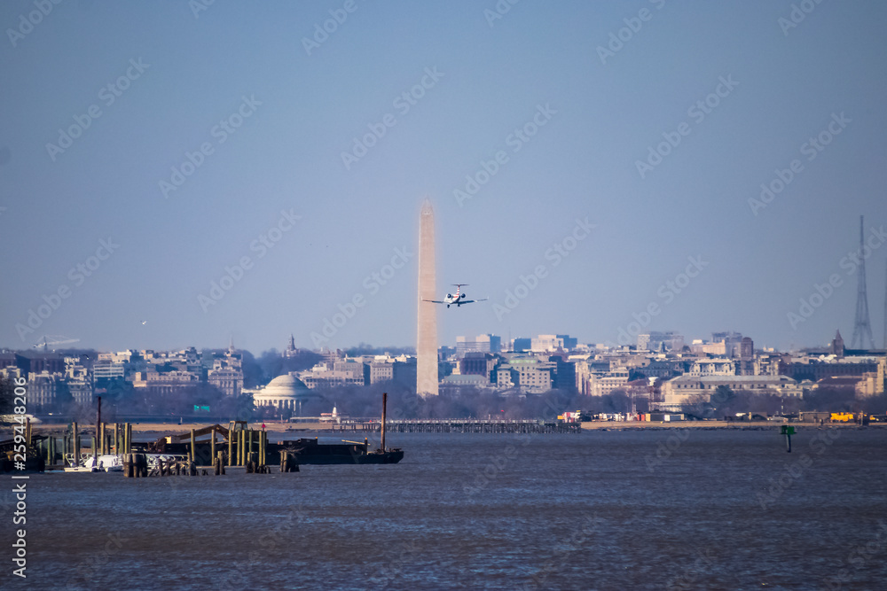 Airplane flying into airport near the DC monuments Stock Photo | Adobe ...