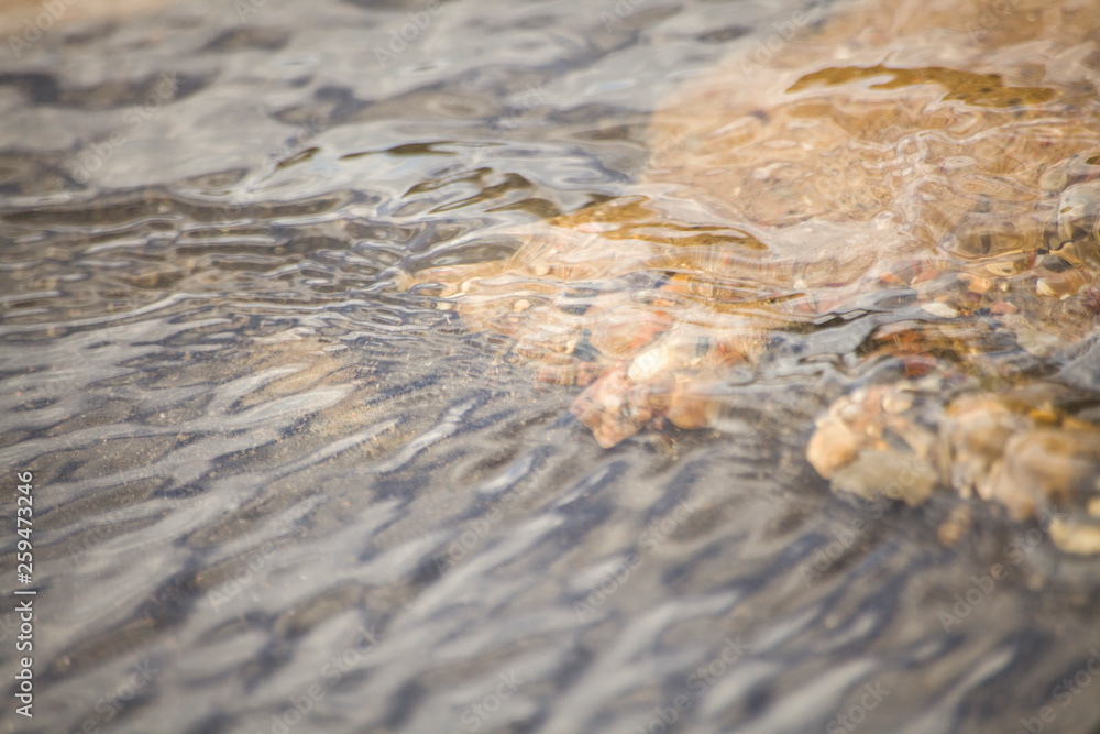 Background water. Asphalt and sand. Stream of water over the asphalt ...
