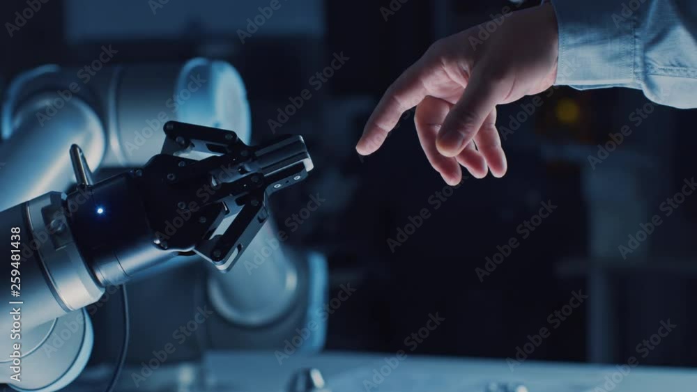 Futuristic Robot Arm Touches Human Hand in Humanity and Artificial ...