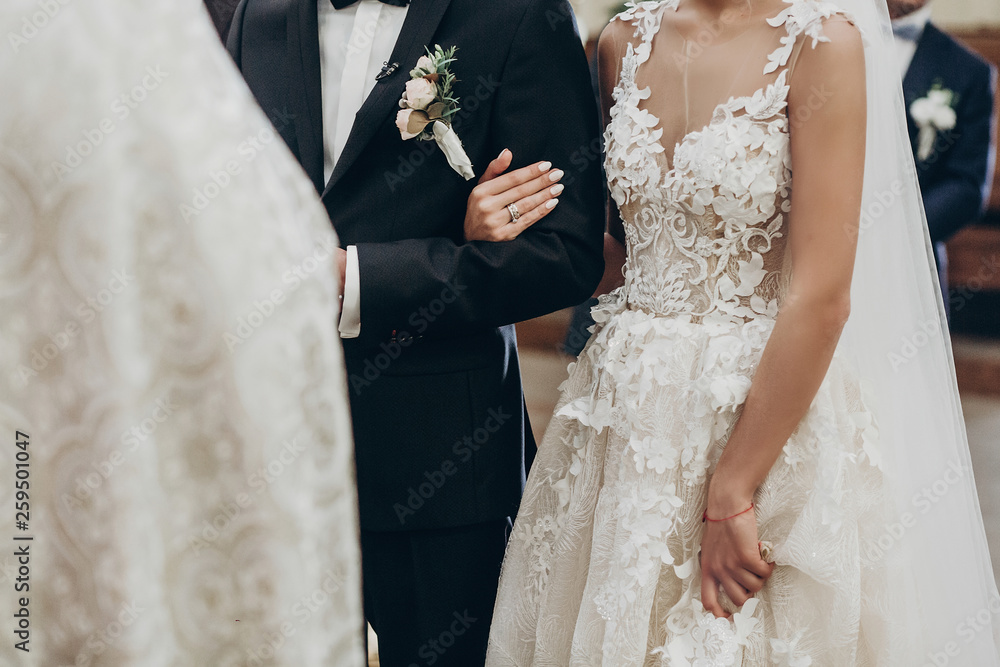 luxury wedding couple hugging, holding hands during traditional wedding ...