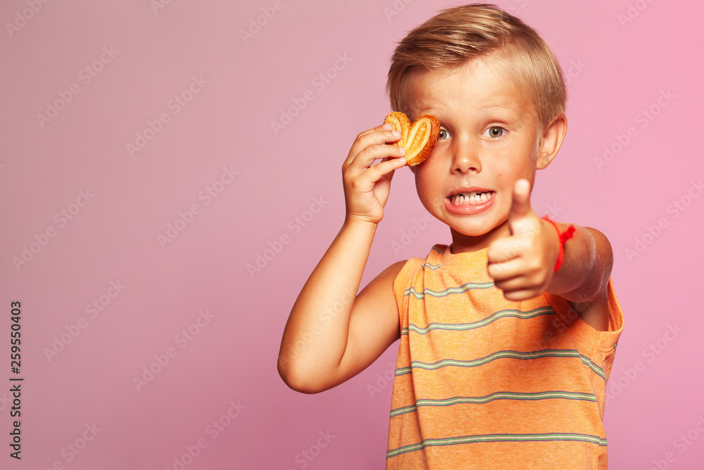 Mama's boy, sweet tooth concept. Funny portrait of shocked boy with ...