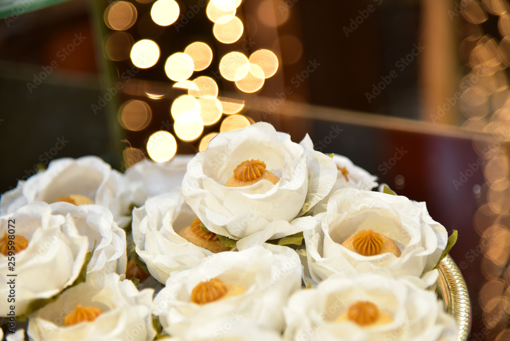 sweets in white flower boxes and bocke in the background, party sweets ...