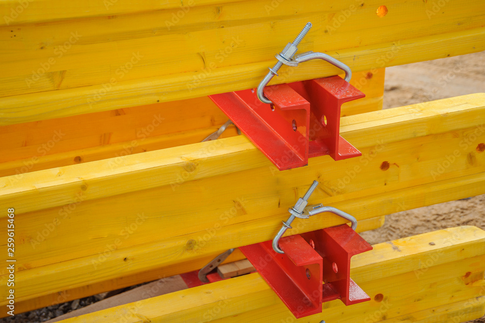 Wooden beams and metal bolts connected clamps for bridge construction ...