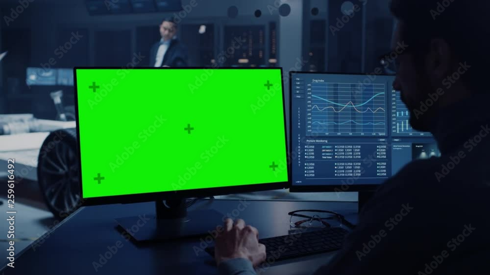 Professional Engineer Works on a Computer with Green Screen Mock Up and ...