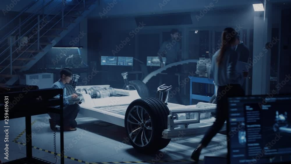 Automotive Design Engineers Work and Do Tests on Electric Car Chassis ...