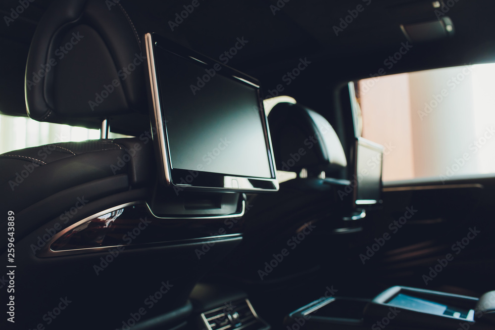 Car inside. Interior of prestige luxury modern car. Three TV displays ...