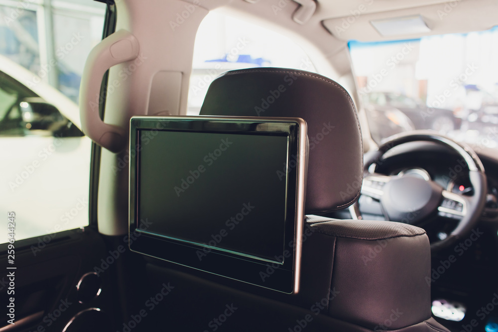 Car inside. Interior of prestige luxury modern car. Three TV displays ...