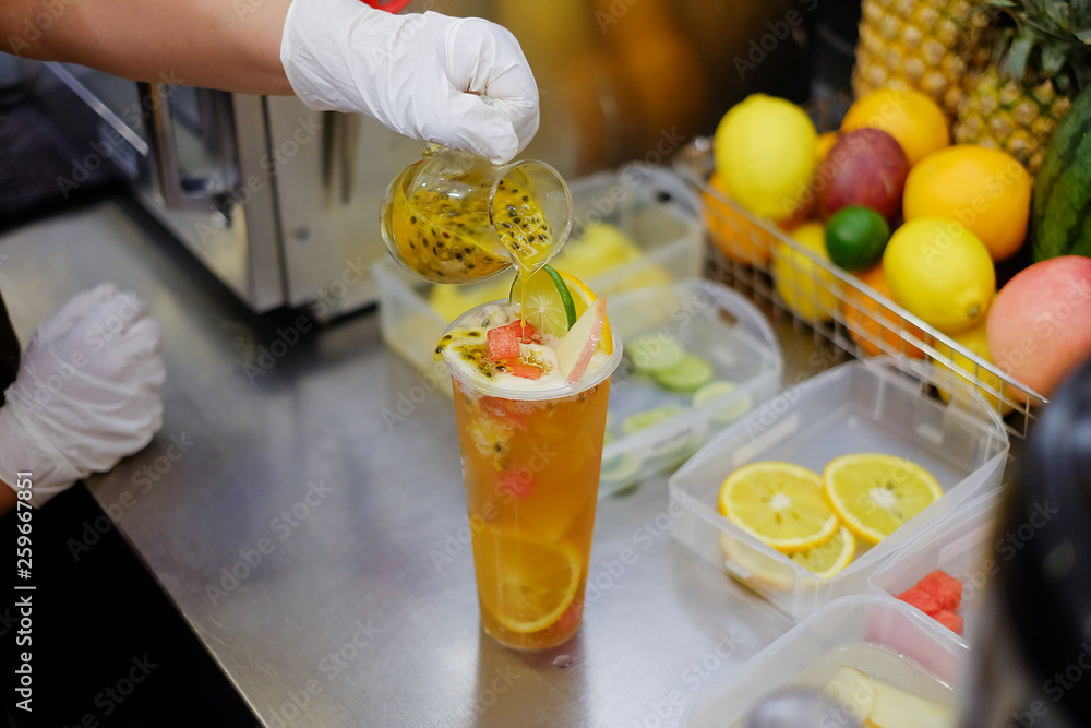 passion fruit juice pouring to mix fruits in plastic glass , summer ...