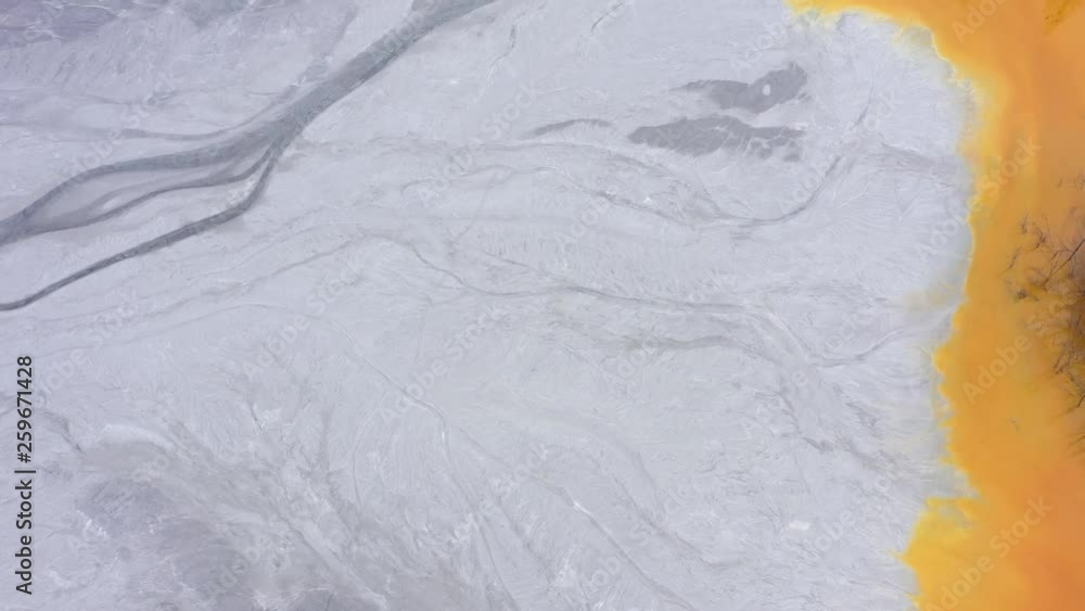 Vidéo Stock Flying over patterns of colorful mining chemical residuals ...