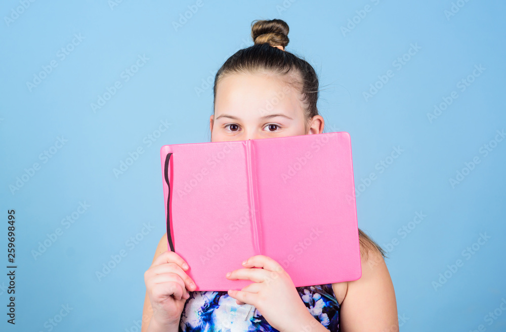 Child cute girl hold notepad or diary blue background. Childhood ...