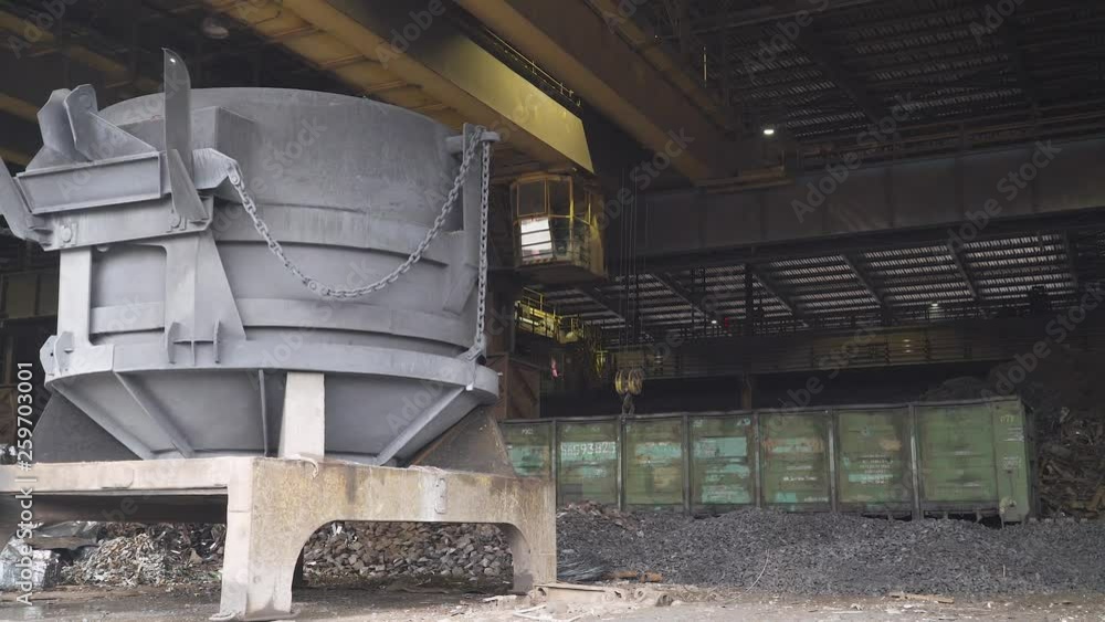 Steelmaking, the process of loading scrap metal into a tank for steel ...