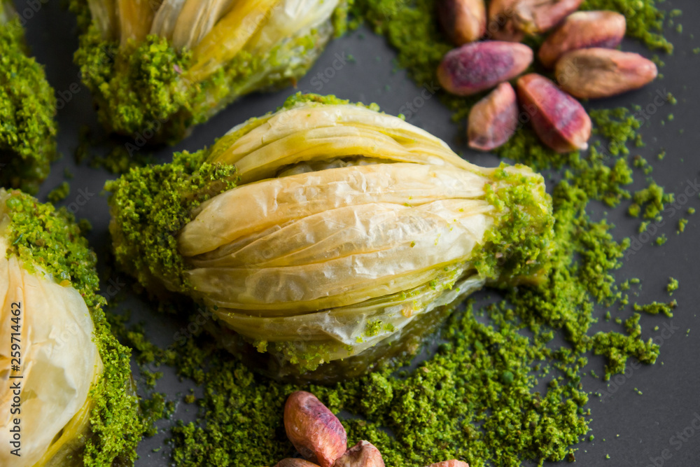 Mussel shaped special Turkish baklava in the grey color round plate ...