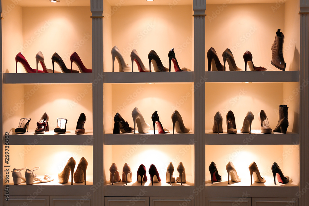Collection of new female shoes on shelves in shop Stock Photo | Adobe Stock