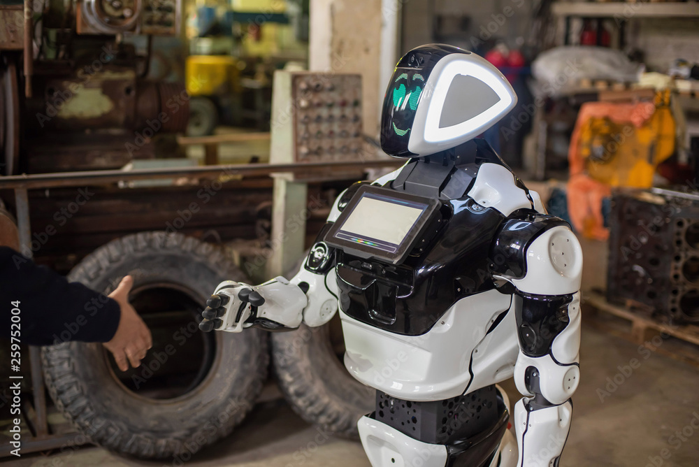 Humanoid robot on wheels with a monitor on his chest, shaking hands ...