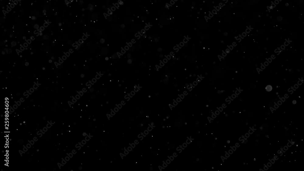 Glowing Particles in the Dark. Small white particles flow in the air on ...