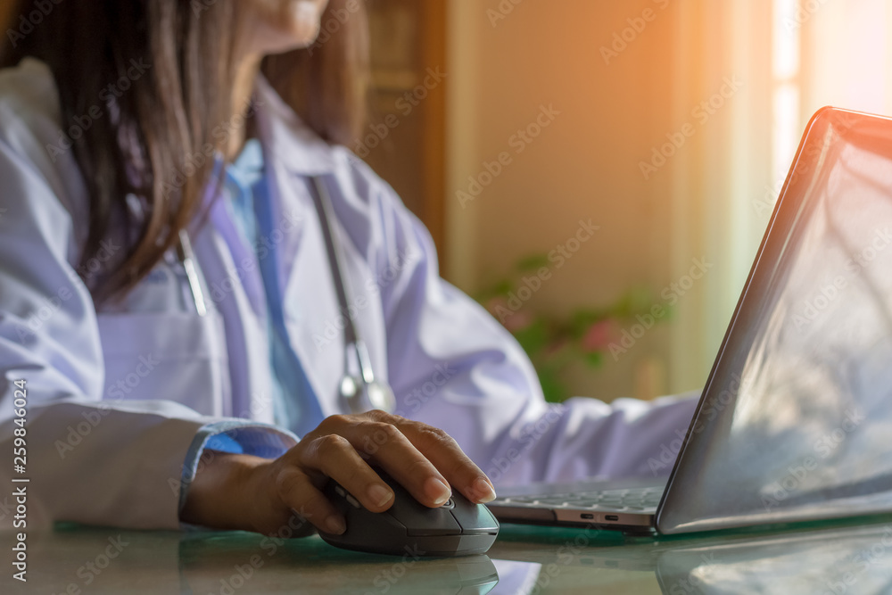 Female doctor or medical student hand using wireless mouse and work on ...