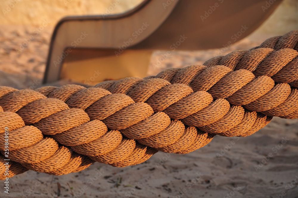 thick balancing rope with slide in background Stock Photo | Adobe Stock