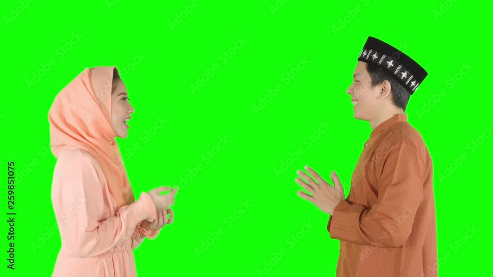 Happy muslim couple giving a greeting hands gesture for forgiving each ...