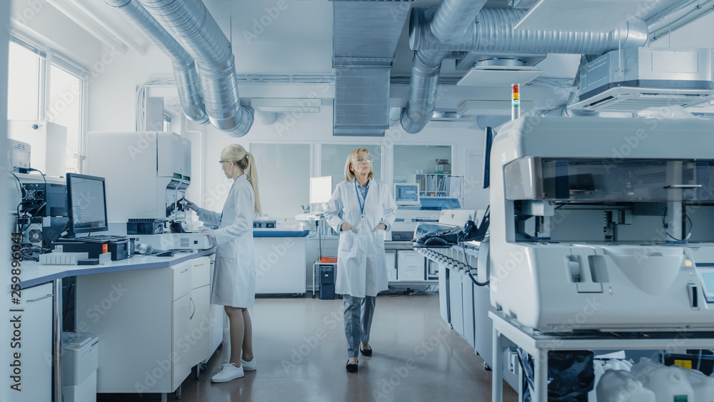 Team of Research Scientists Working On Computer, with Medical Equipment ...