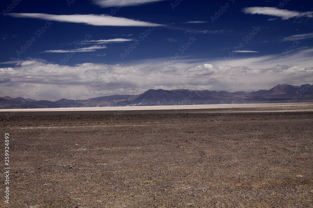 View over endless dried barren land on blurred mountain range in the ...